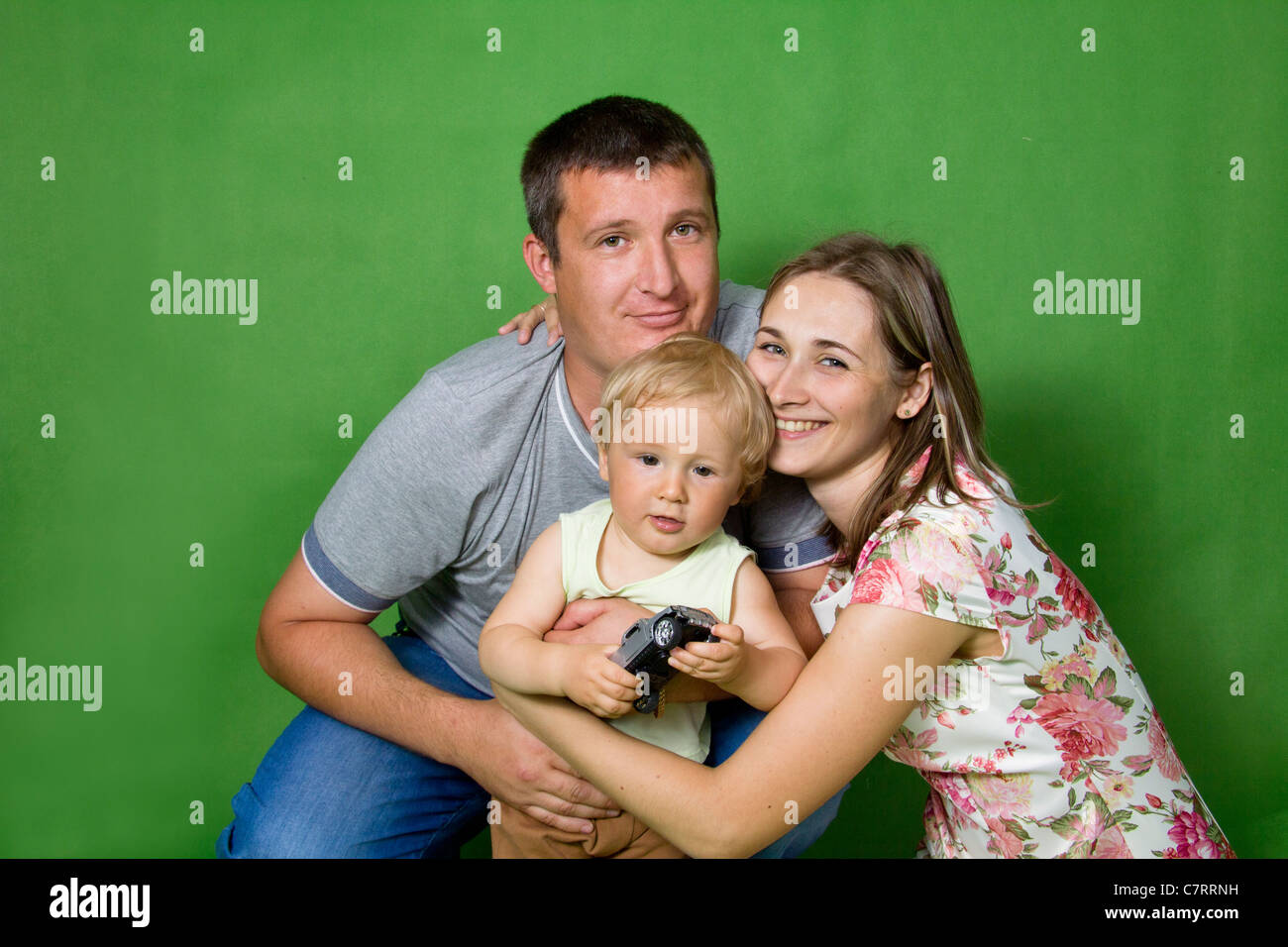 Young European family from three persons - mother, father and son. On a ...