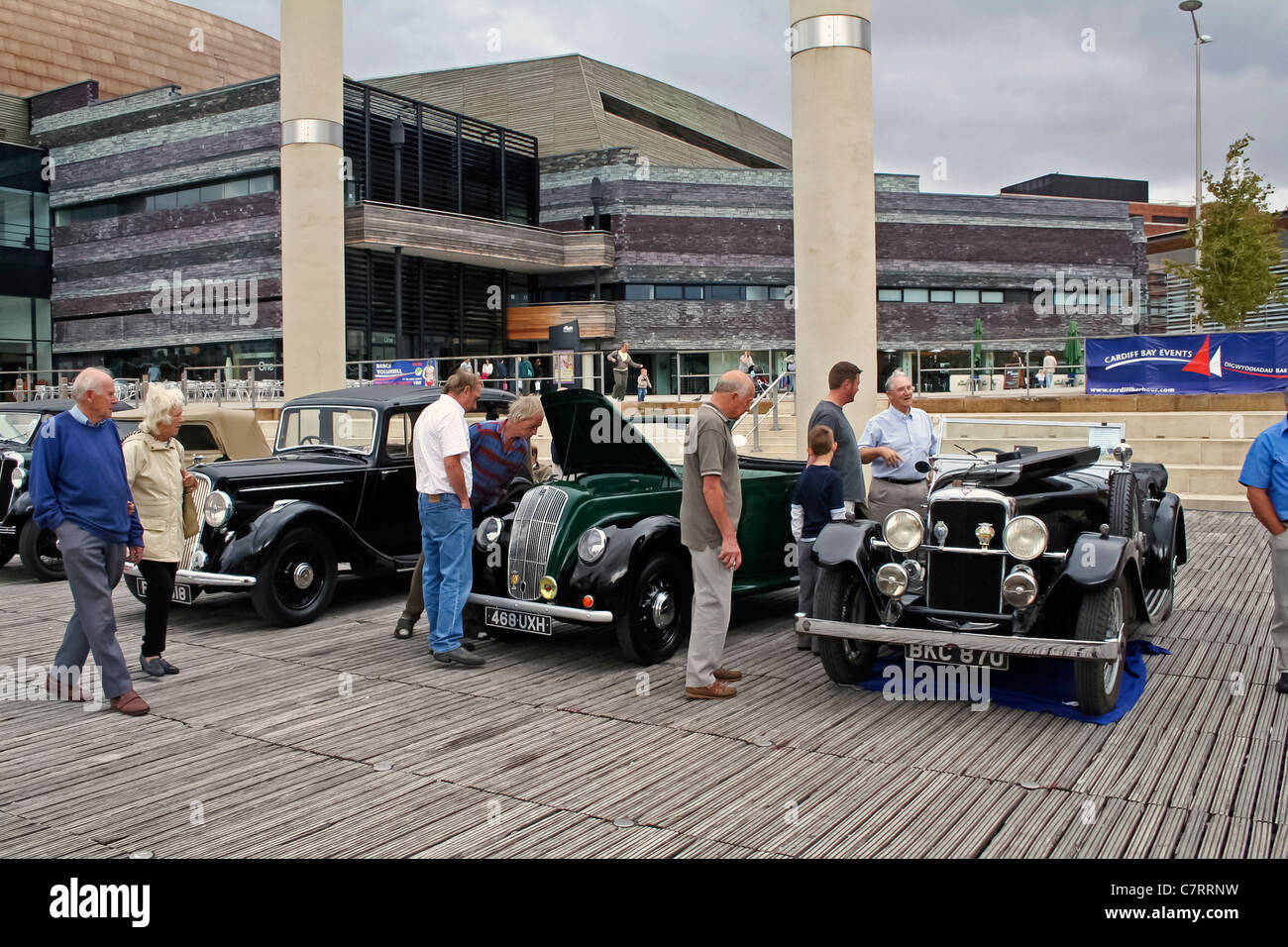 A classic car show held in Cardiff Bay featuring vintage vehicles, each ...
