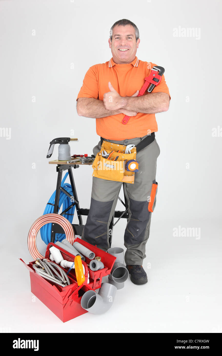 Smiling man at workbench with tools Stock Photo - Alamy