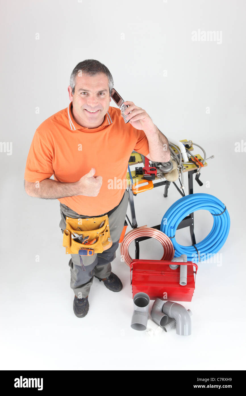 full-length portrait of experienced craftsman making a call Stock Photo ...