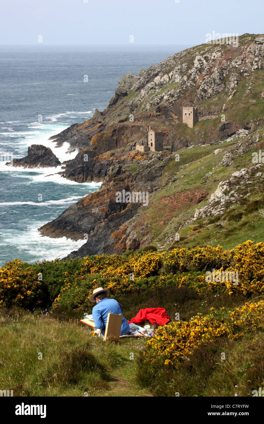 An artist paints engine houses at Botallack Stock Photo - Alamy