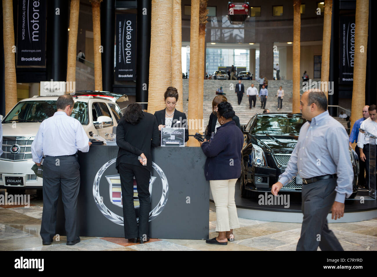 Customers at the service desk for Cadillac luxury vehicles on display ...