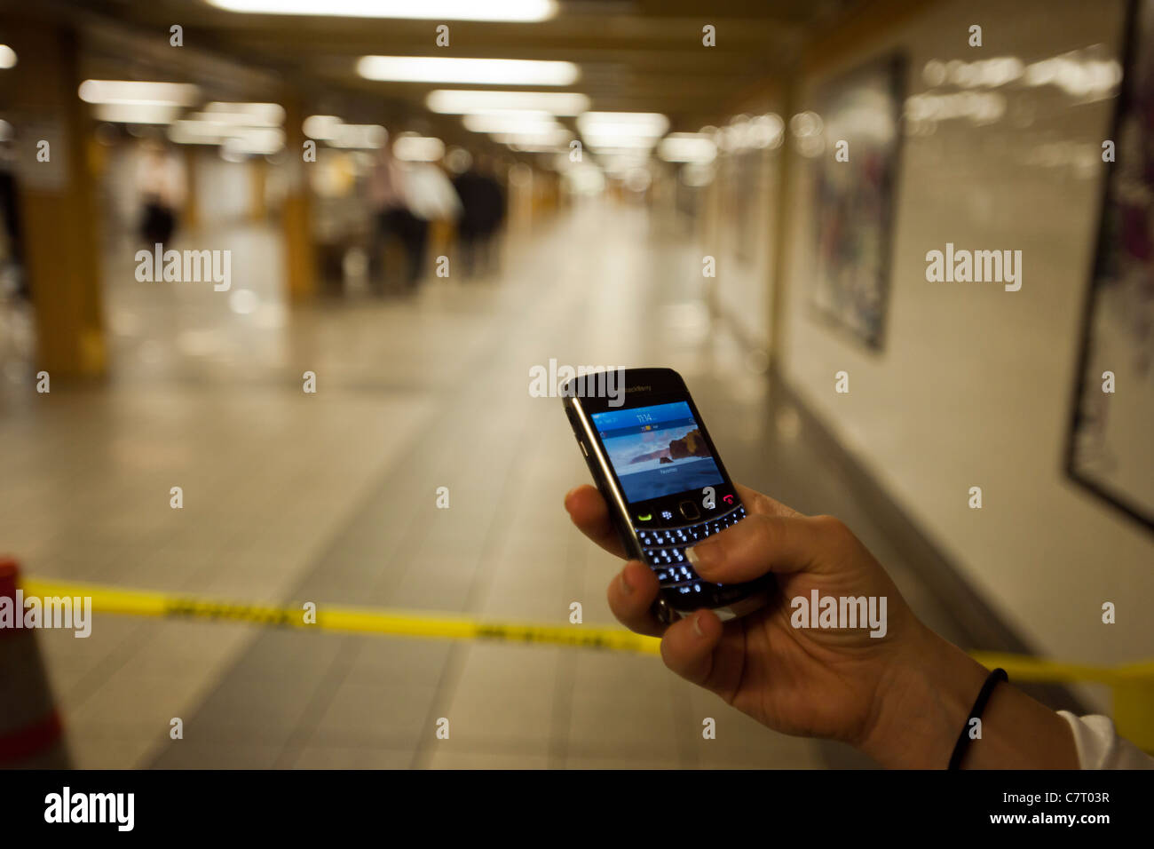 Subway riders demonstrate service on their cell phones at the W14th ...