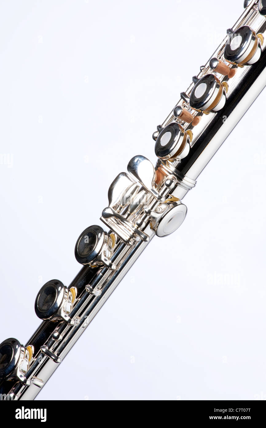 A silver flute key section isolated against a white background in the ...