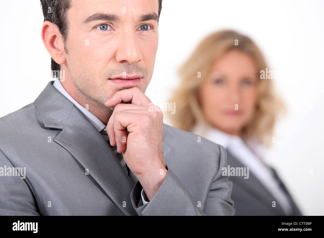 Businessman resting his hand on his chin Stock Photo - Alamy