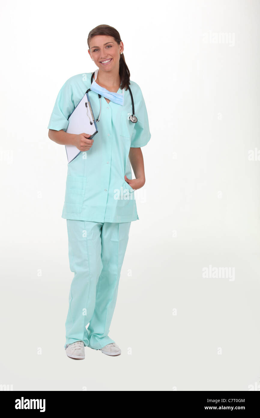 Woman in scrubs with stethoscope and clipboard Stock Photo - Alamy