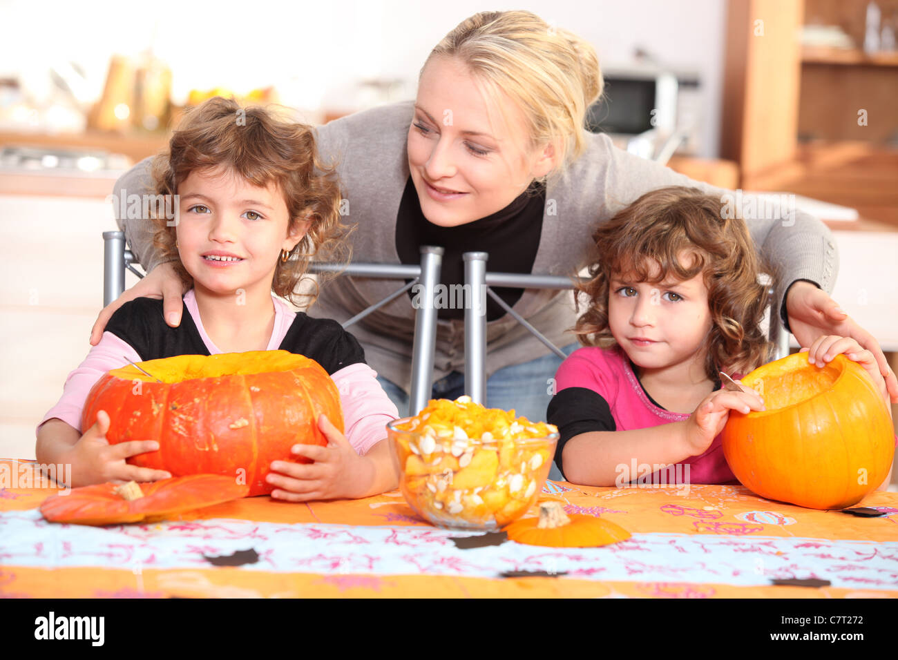 Family carving pumpkins together Stock Photo - Alamy
