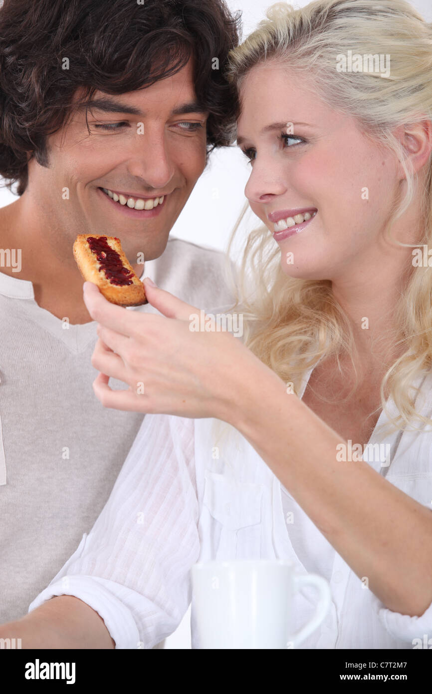 Couple eating biscuit's for breakfast Stock Photo - Alamy
