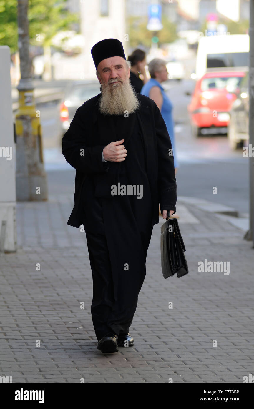 Orthodox priest walking down the street on Cluj-Napoca (Romania Stock ...