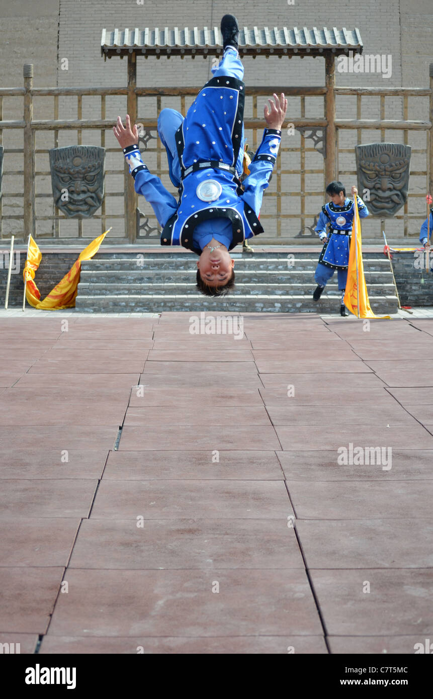 Performers dressed as warriors perform a show of acrobatics and martial ...