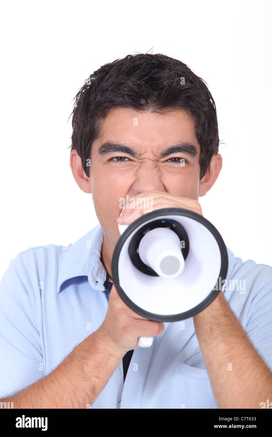 Teenager shouting into loud speaker Stock Photo - Alamy
