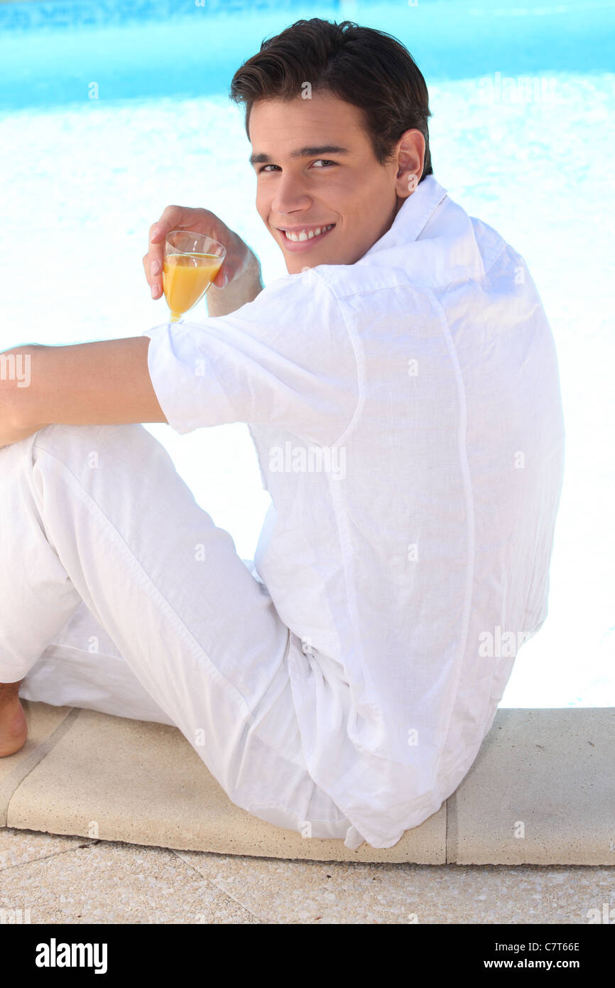 young man drinking cocktail on the beach Stock Photo - Alamy