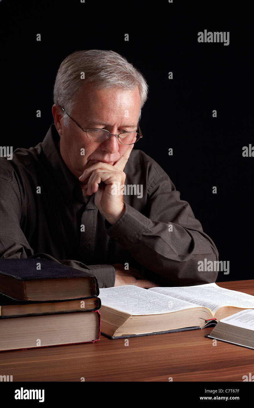 Senior pastor meditating and searching guidance Stock Photo - Alamy