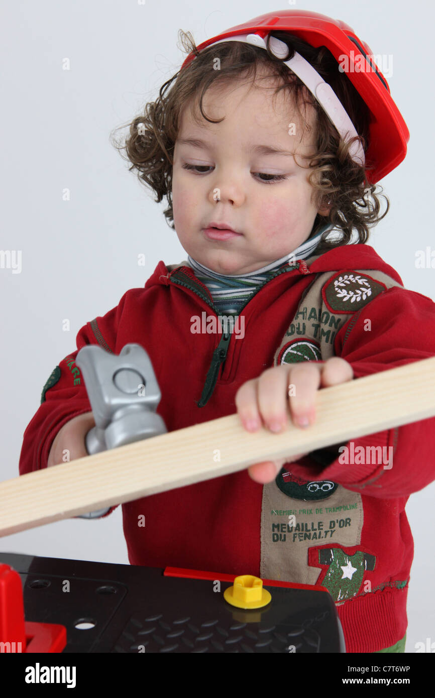 Little boy playing builder Stock Photo - Alamy