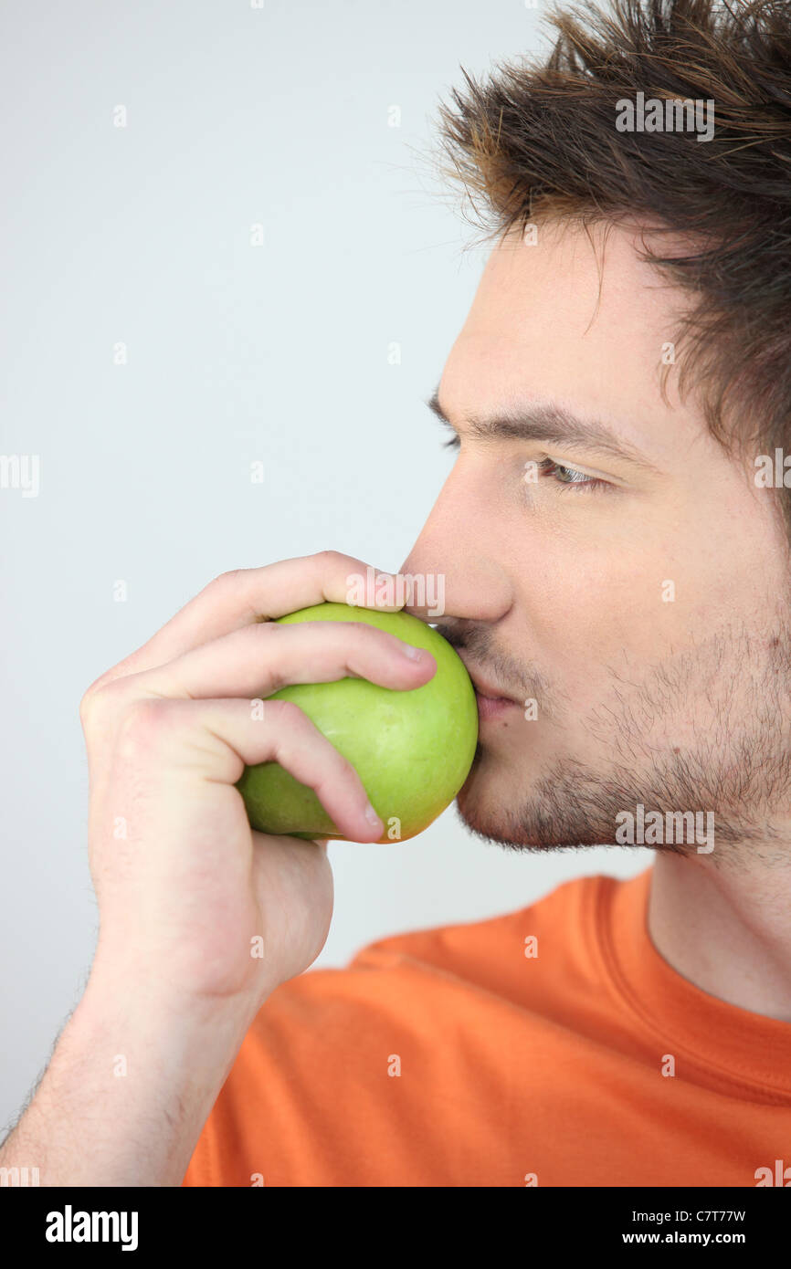 Man kissing a green apple Stock Photo - Alamy