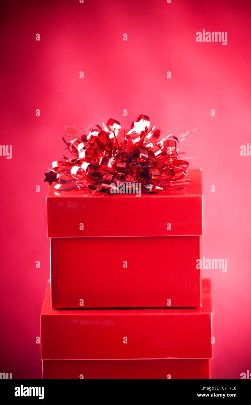 Bright red gift boxes with decoration on a blurred red background Stock ...