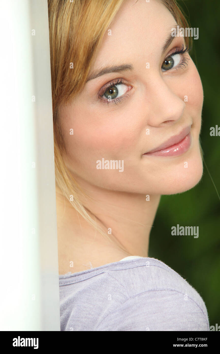 Young woman looking over her shoulder Stock Photo - Alamy
