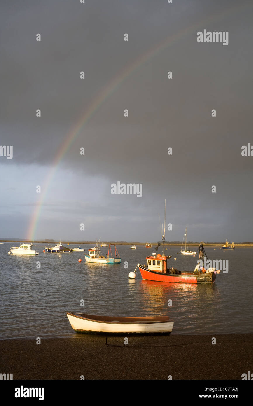 A rainbow over the water in a brooding, stormy sky Stock Photo - Alamy