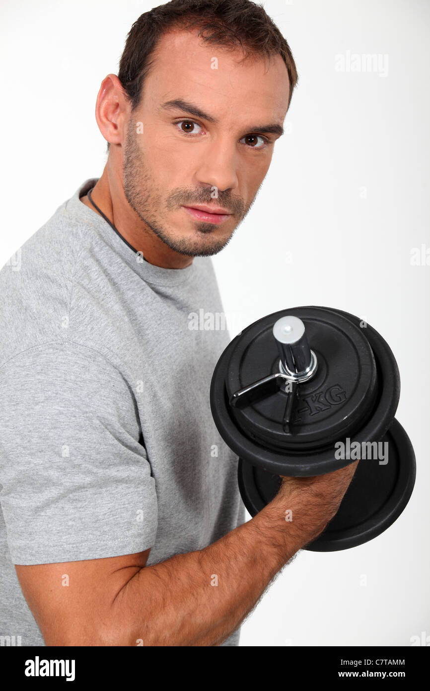 Man lifting a dumbbell Stock Photo - Alamy
