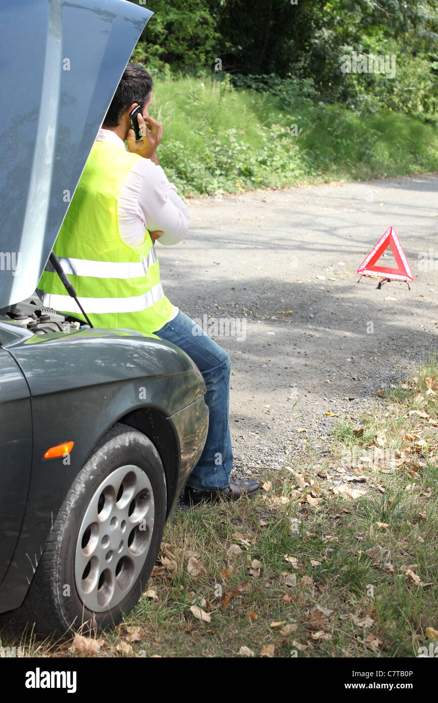 Man sat by car waiting for roadside assistance Stock Photo - Alamy