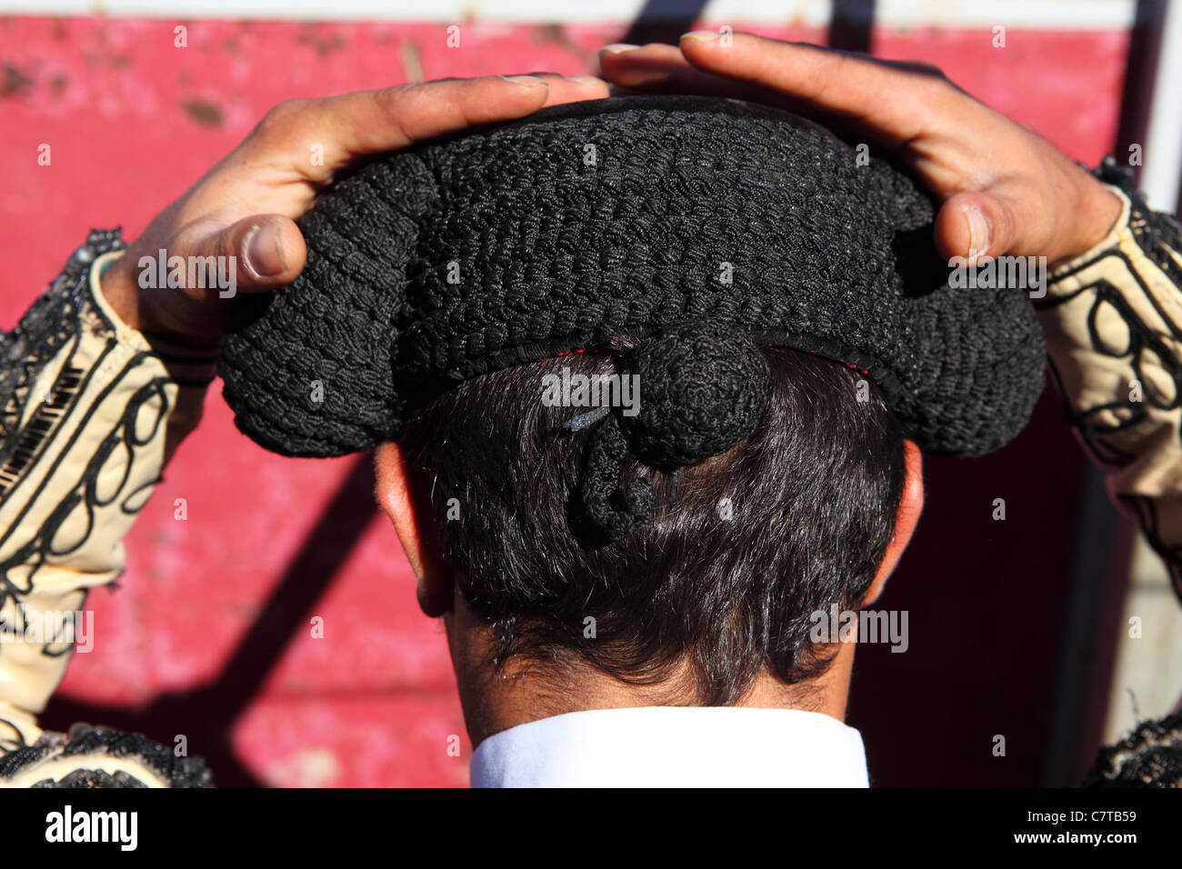 A bullfighter (Bandarilheiro) puts his hat (Montera) in position prior ...