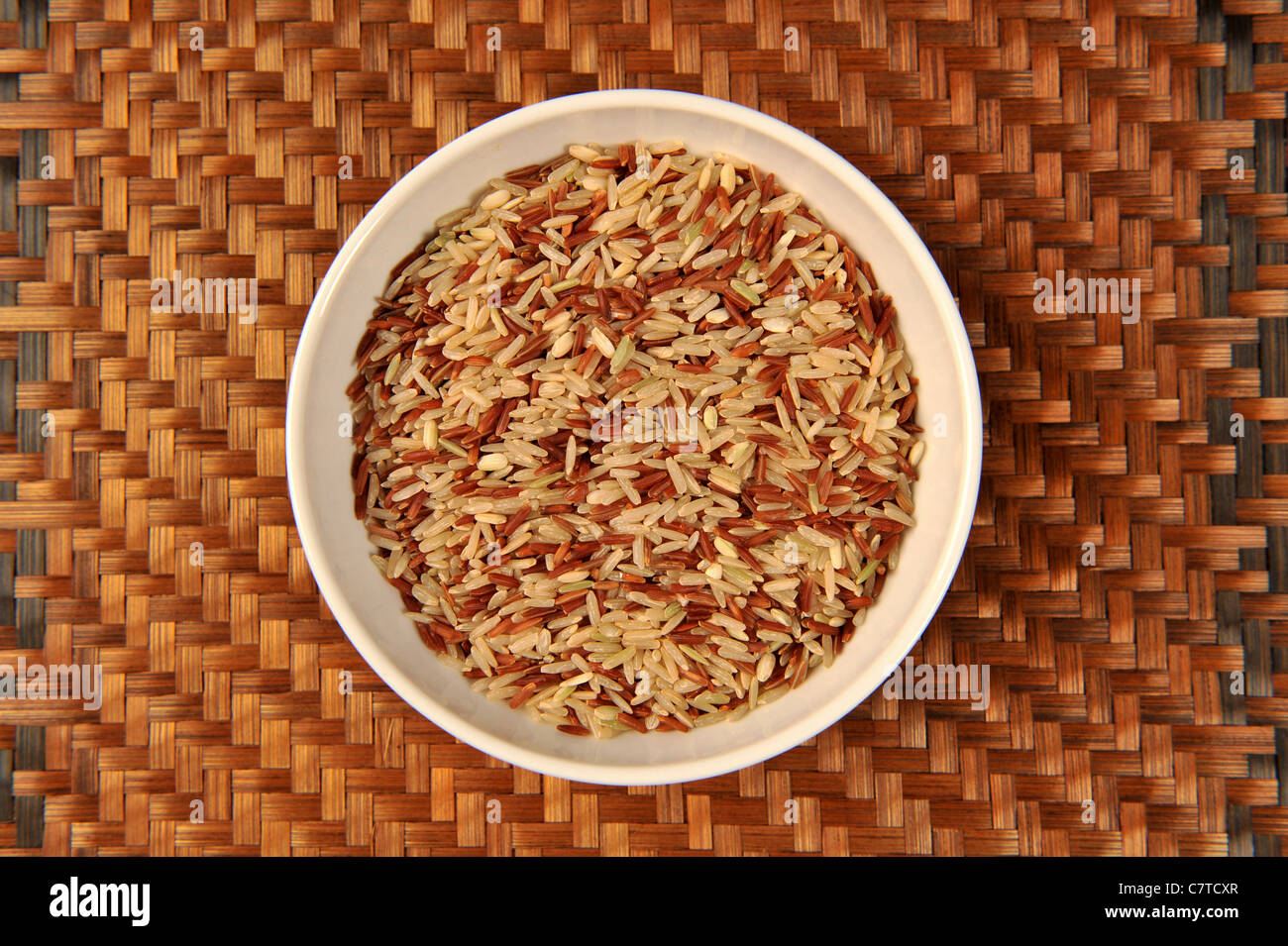 Bowl of brown rice, over bamboo background. Overhead view Stock Photo ...