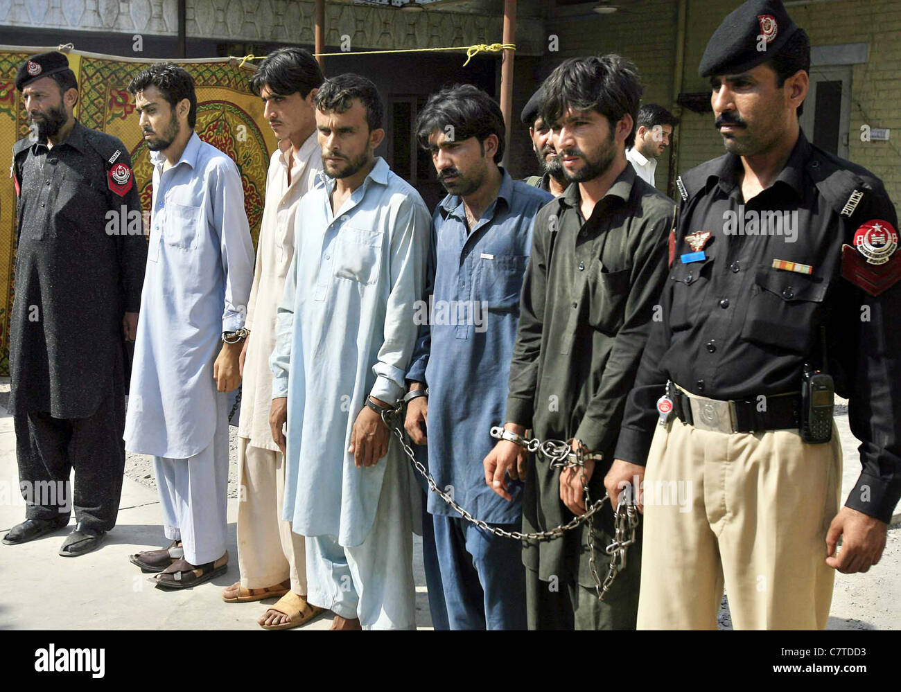 Policemen escort handcuffed dacoits who were involved in dacoity of ...