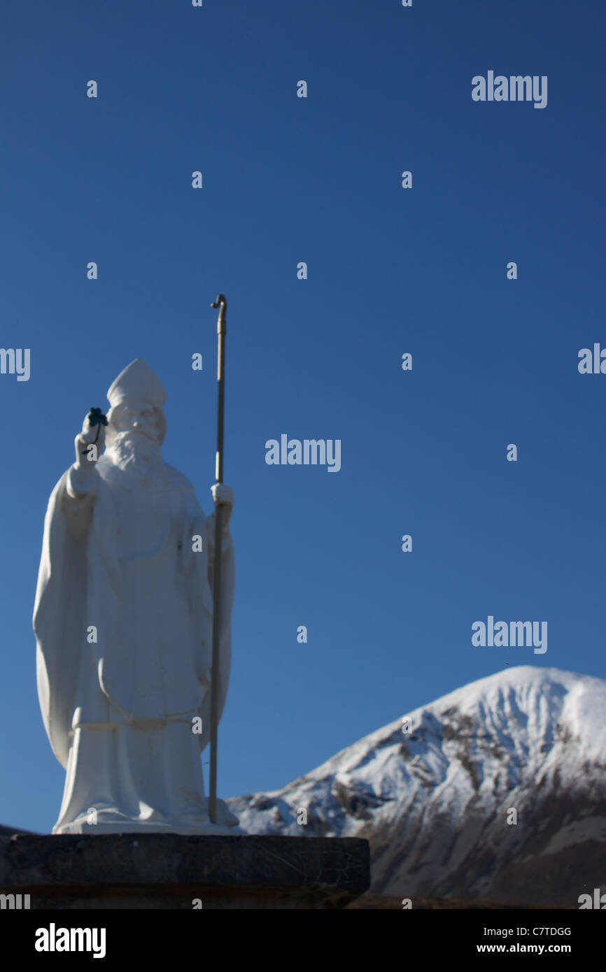 The statue of st Patrick with the blue sky and Croagh Patrick mountain ...