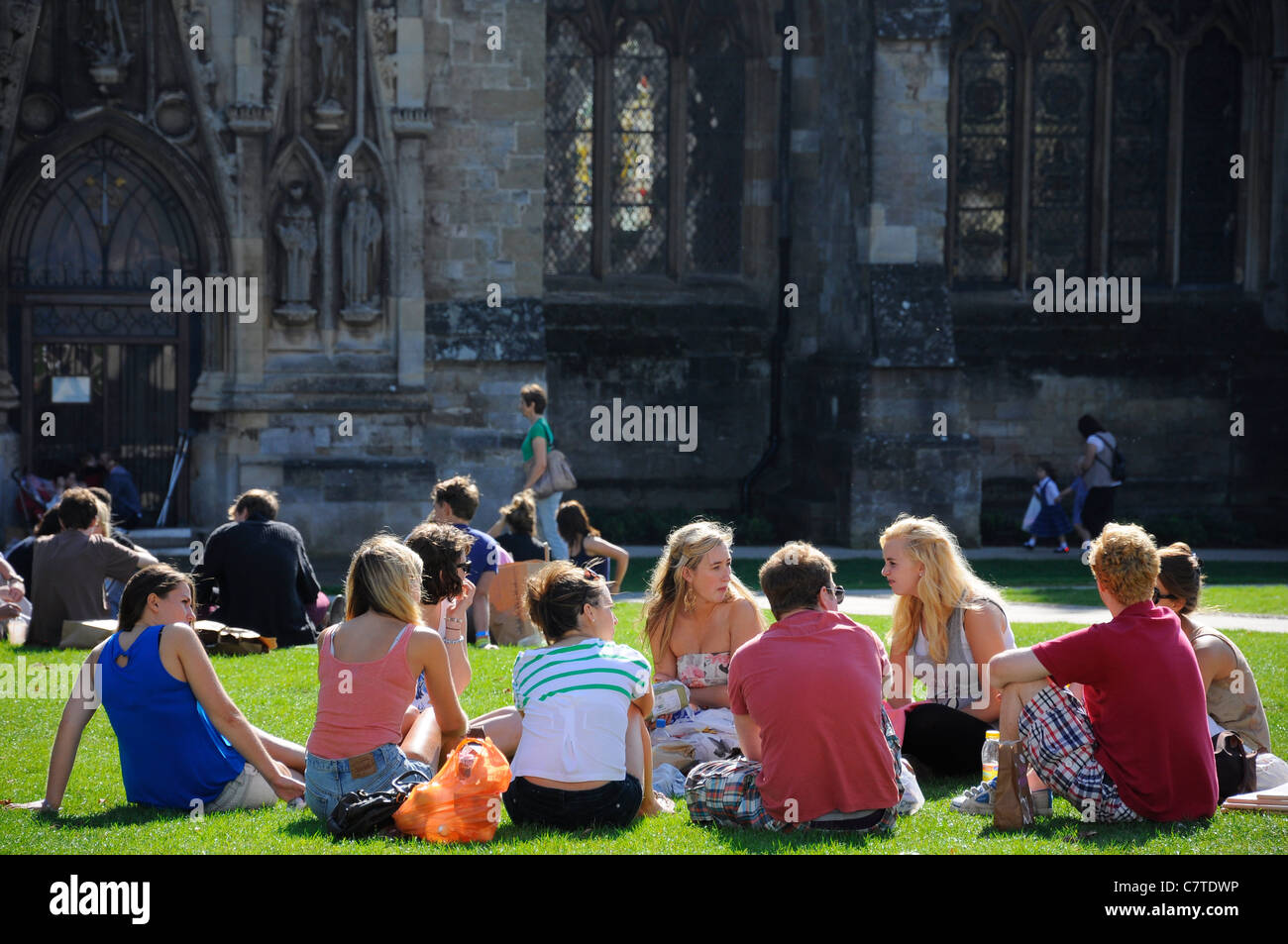 Groups of people outside enjoying sunshine on Cathedral Green, Exeter ...
