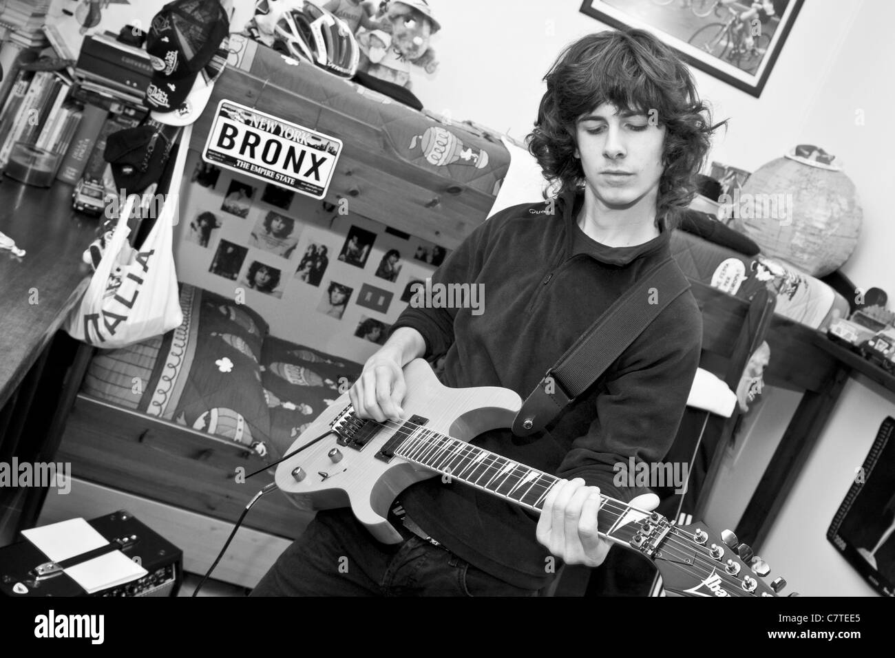 Teenage boy playing bass guitar at home Stock Photo - Alamy