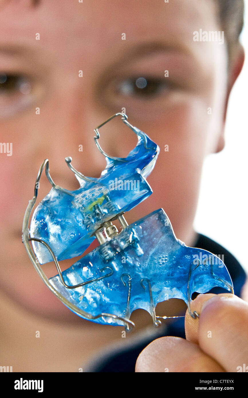 Boy holding orthodontic braces Stock Photo - Alamy