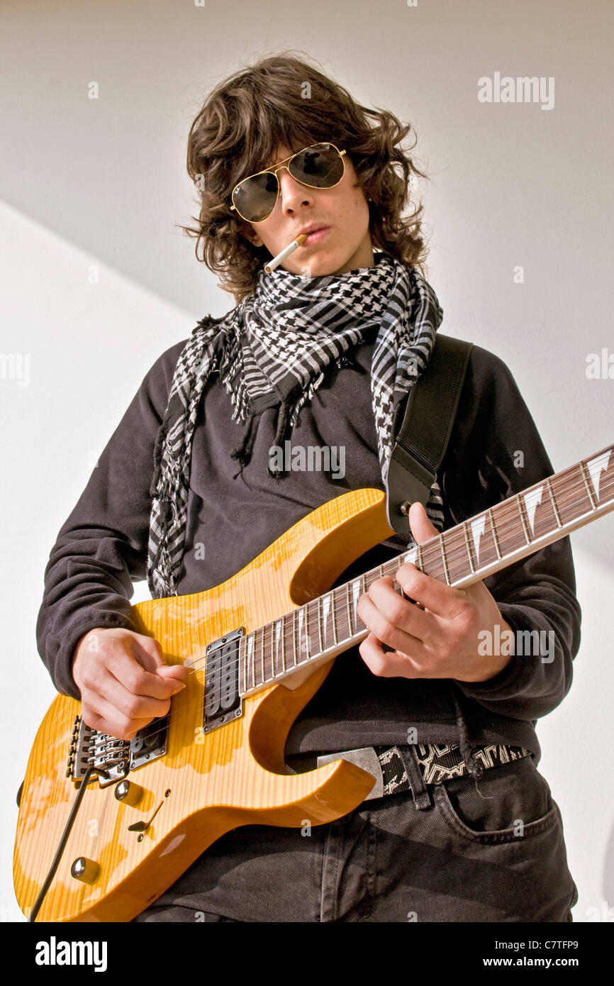 Teenage boy playing bass guitar Stock Photo - Alamy