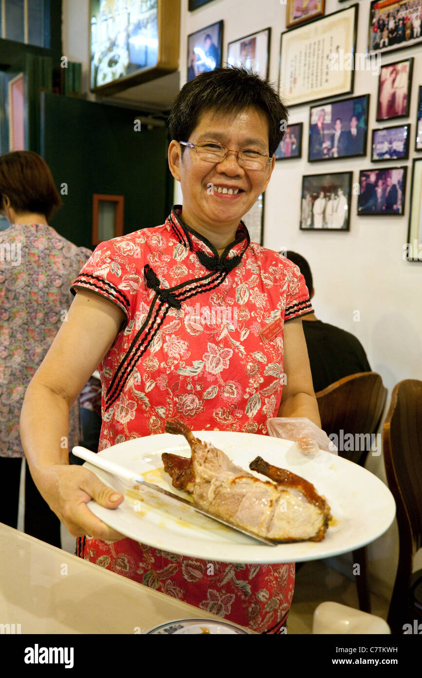 A waitress preparing Crispy duck in a Chinese restaurant, Chinatown ...