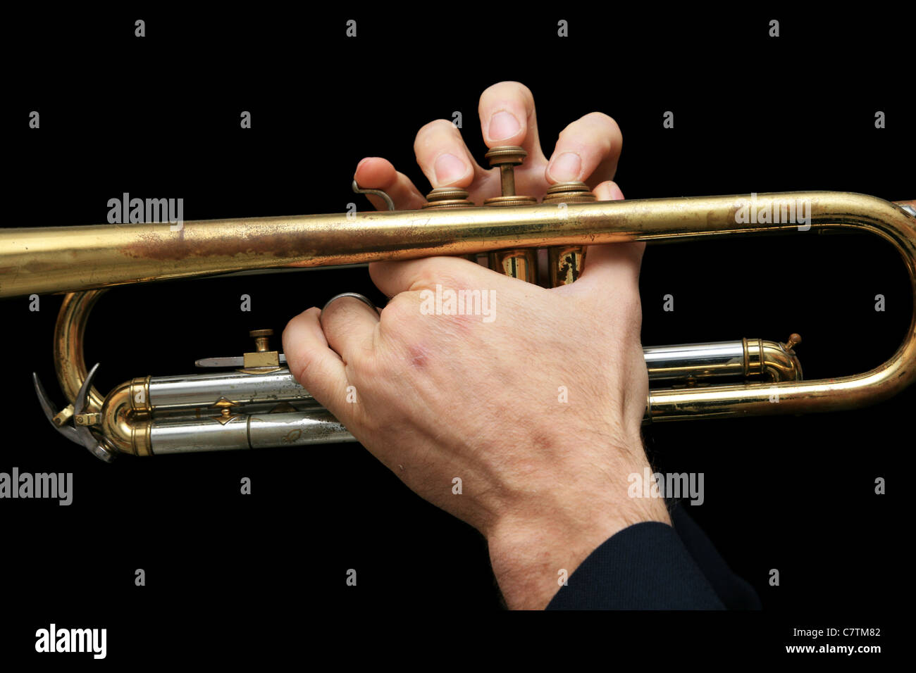 detail of a man's hands playing a trumpet with dark background Stock ...