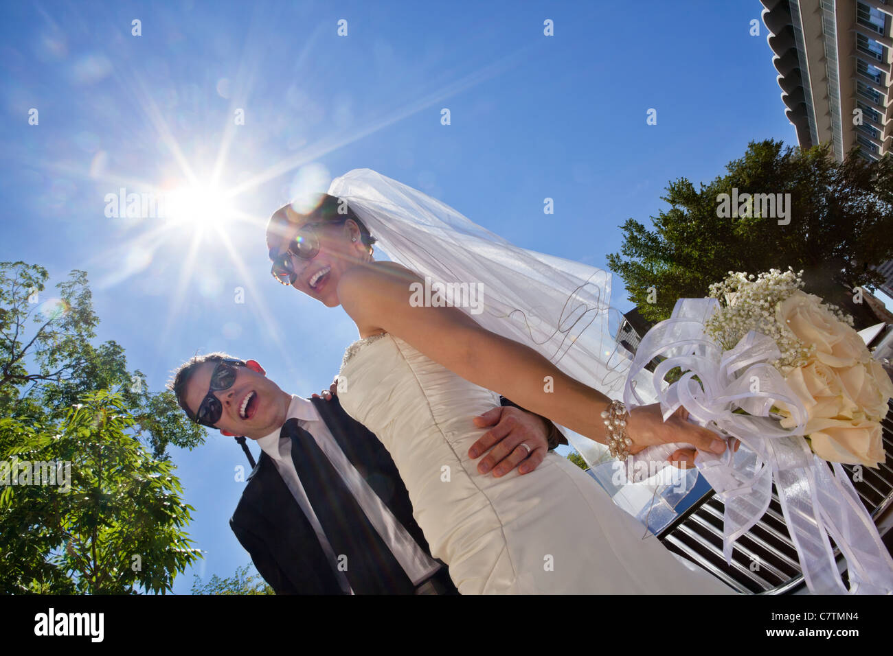 Low angle view of happily married couple in sunglasses Stock Photo - Alamy