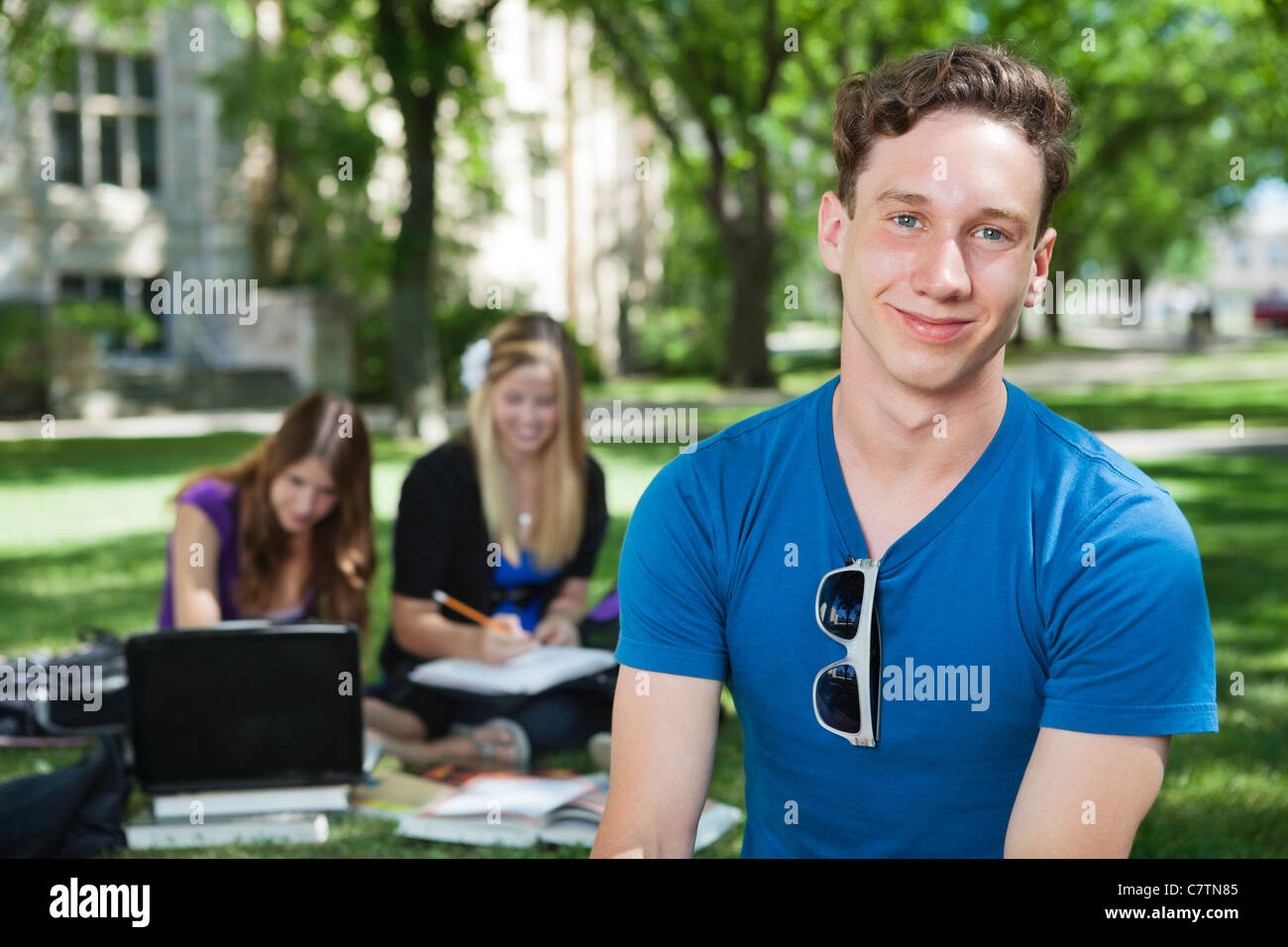 Portrait of happy college student with classmates in background Stock ...