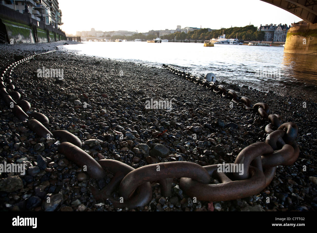 A giant chain lays below the tide line on the river Thames in London ...