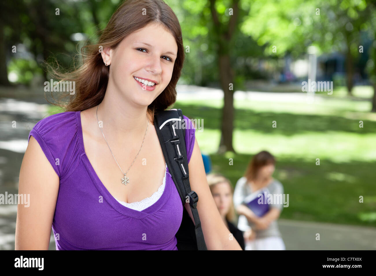 Portrait Of A Sweet College Girl Smiling With Friends In Background