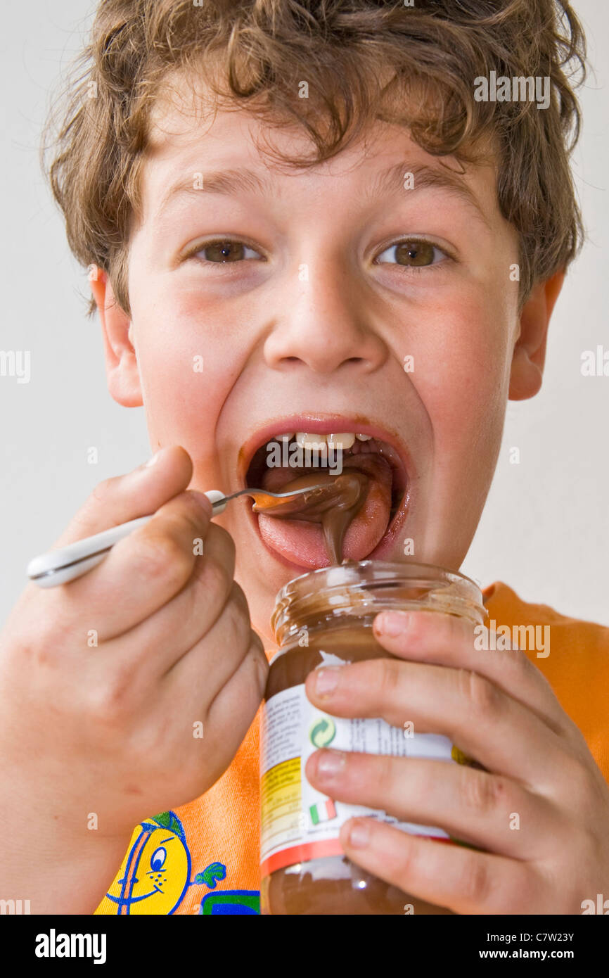 Boy eating chocolate Stock Photo - Alamy