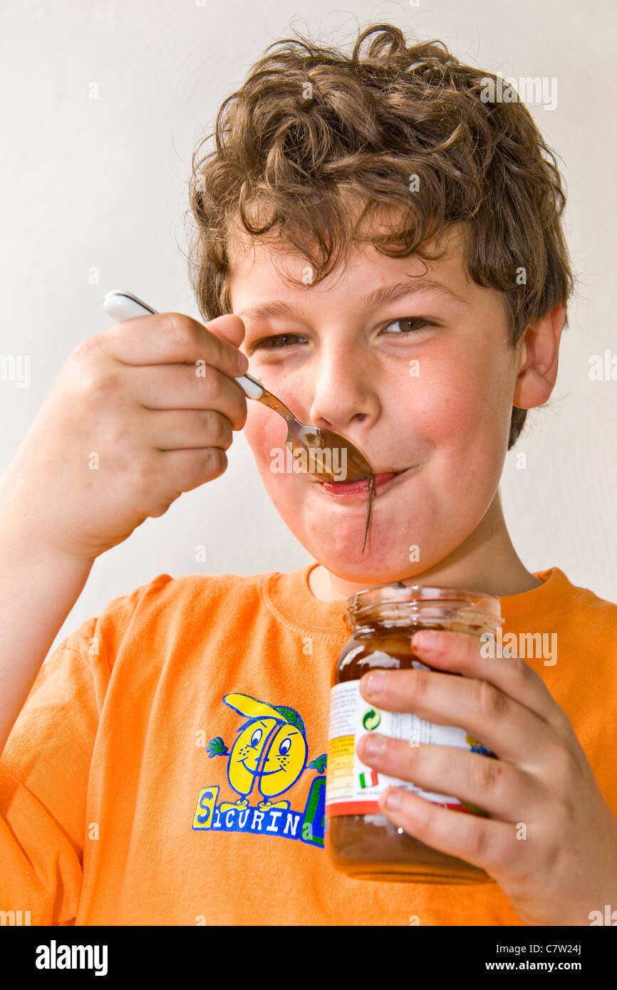 Boy eating chocolate Stock Photo - Alamy