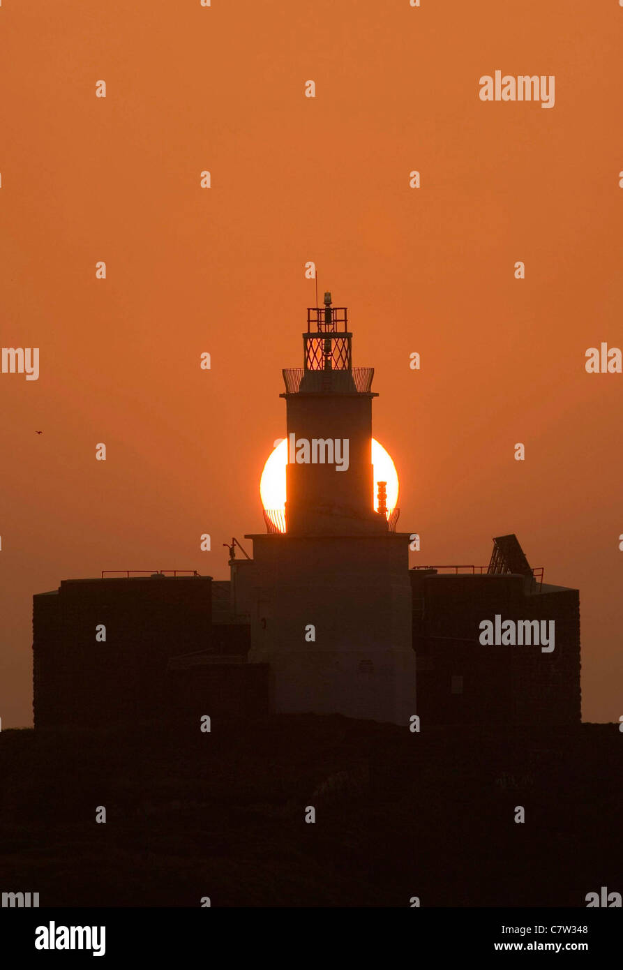 The sun rises above the Mumbles lighthouse in Swansea Bay at dawn to ...