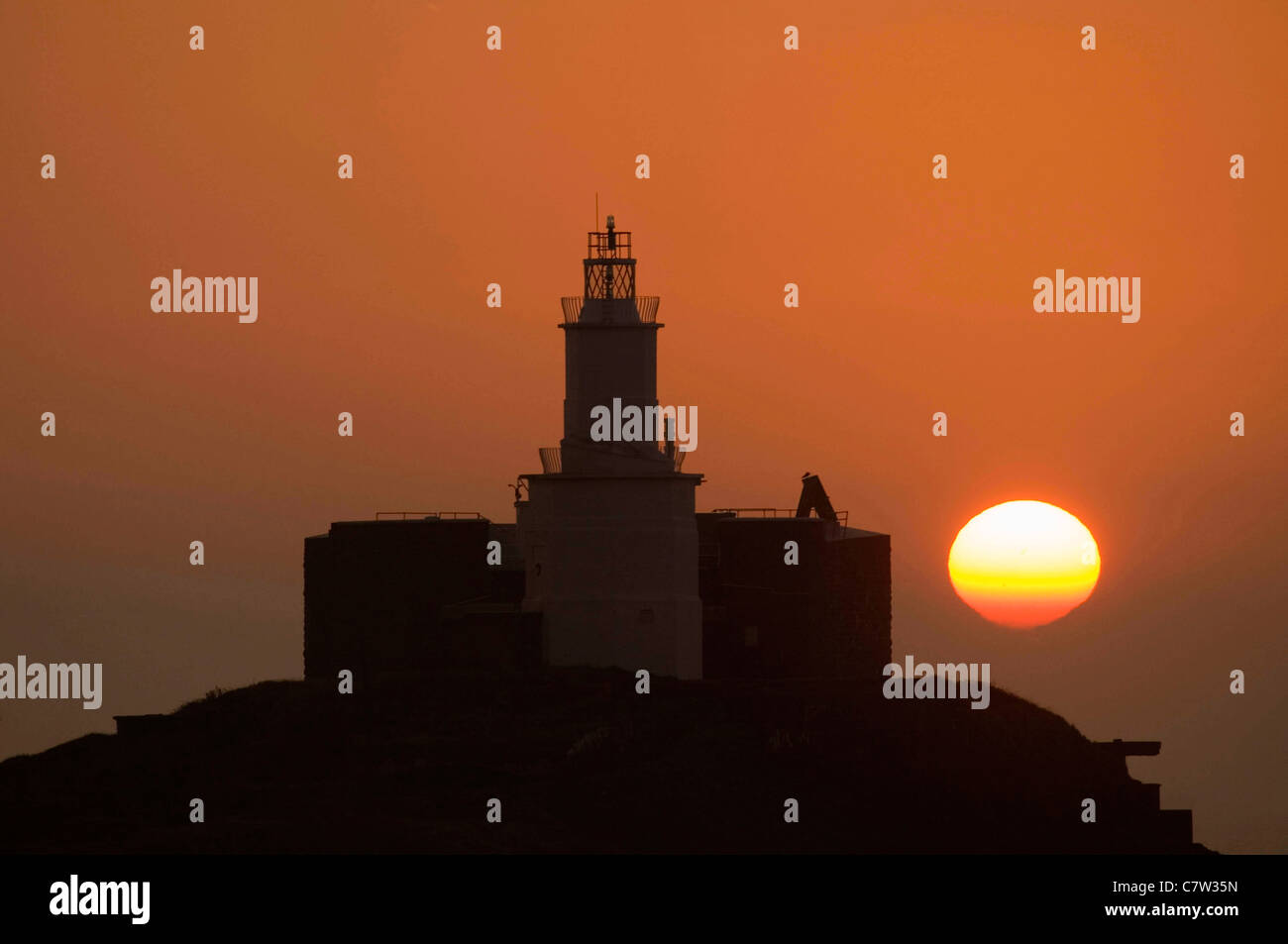 The sun rises above the Mumbles lighthouse in Swansea Bay at dawn to ...