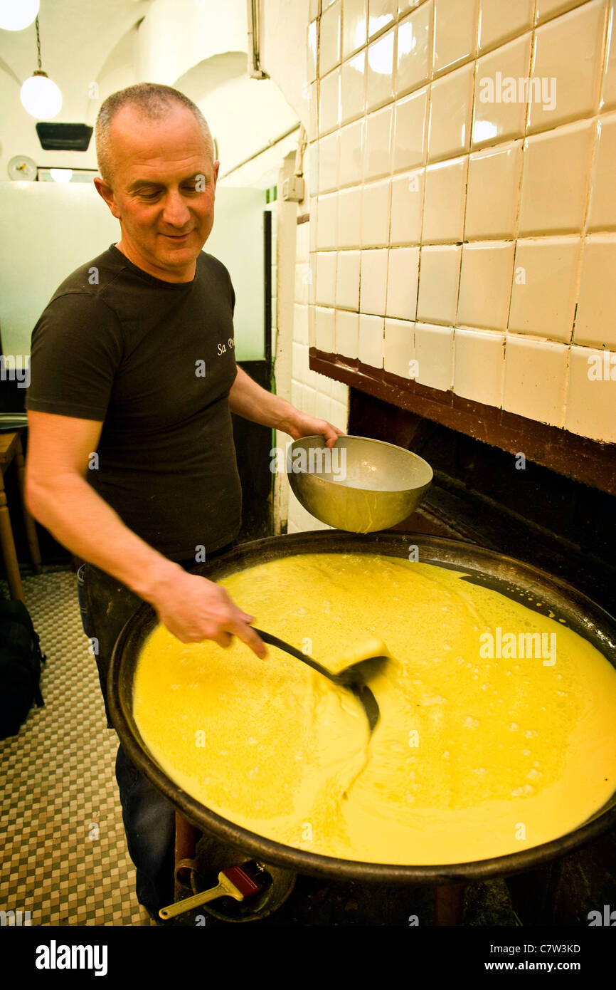 Italy, Liguria, Genova, antica Sa Pesta. Making of typical Farinata ...