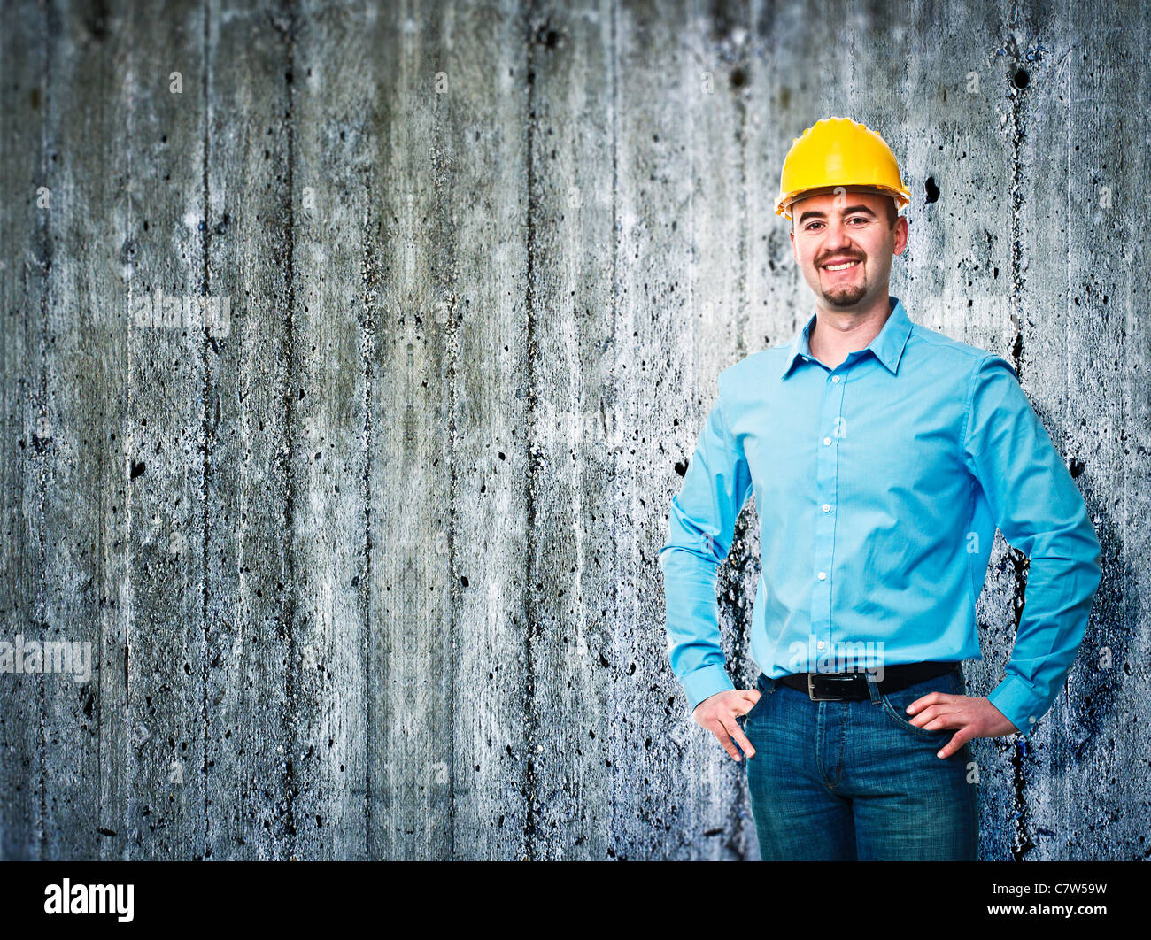 smiling worker and concrete texture background Stock Photo - Alamy
