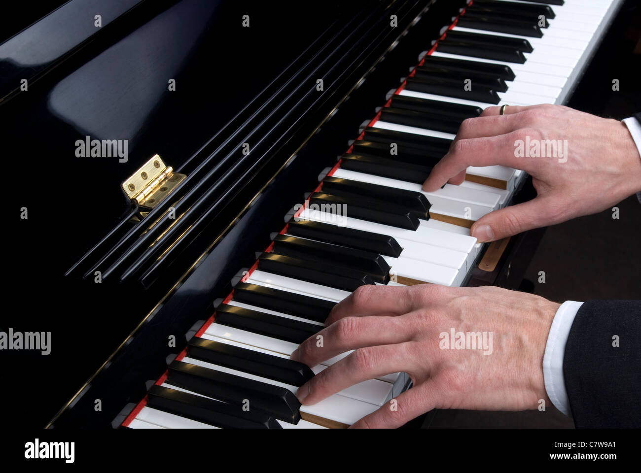 Man playing the piano, zoomed in on hands and piano keys Stock Photo ...