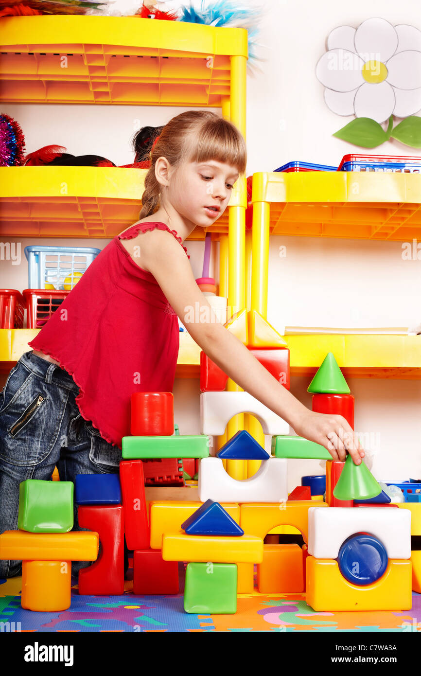 Child with puzzle, block and construction set in play room Stock Photo ...