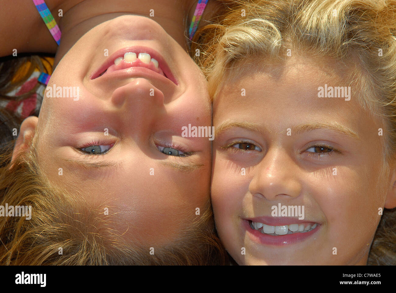 Two young girls smiling Stock Photo - Alamy