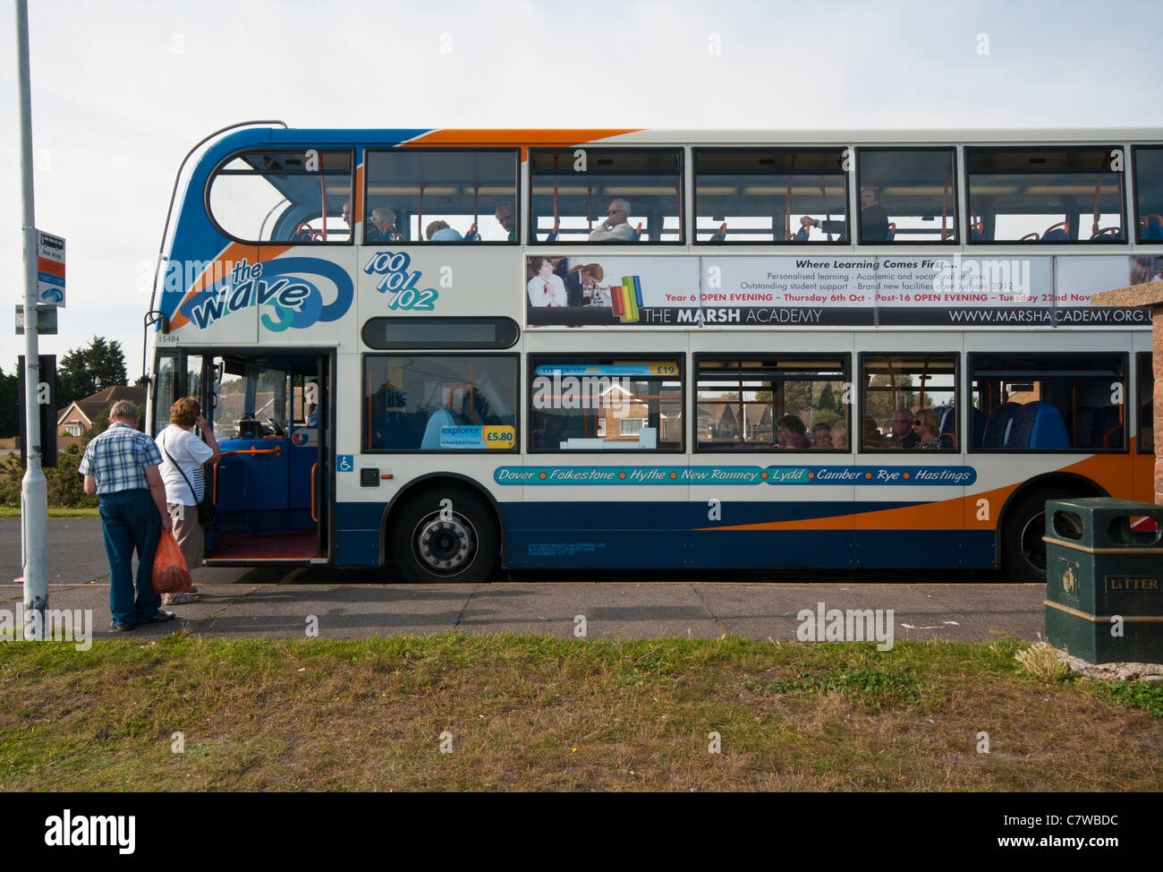 UK Rural Bus Service Bus At A Bus Stop With Passengers Boarding Stock ...