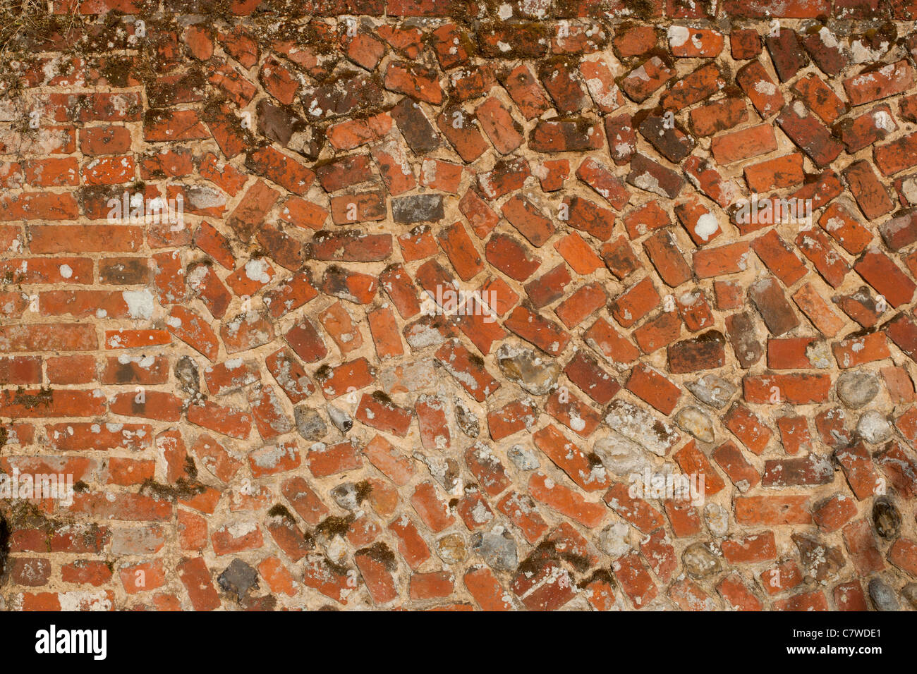 Red brick wall with bricks at odd angles Stock Photo - Alamy
