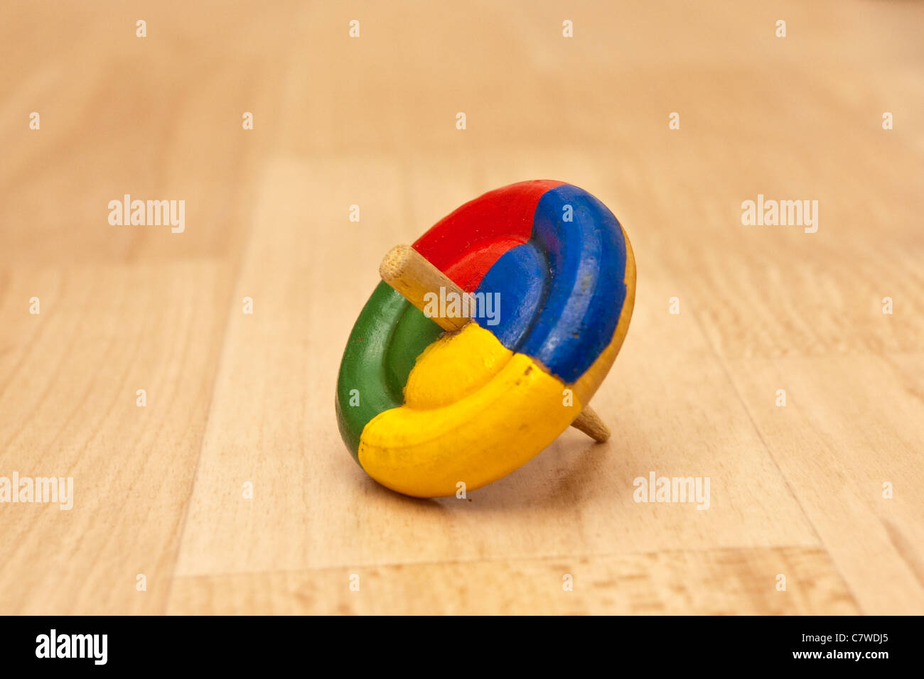Traditional wooden spinning top on a wooden surface Stock Photo - Alamy